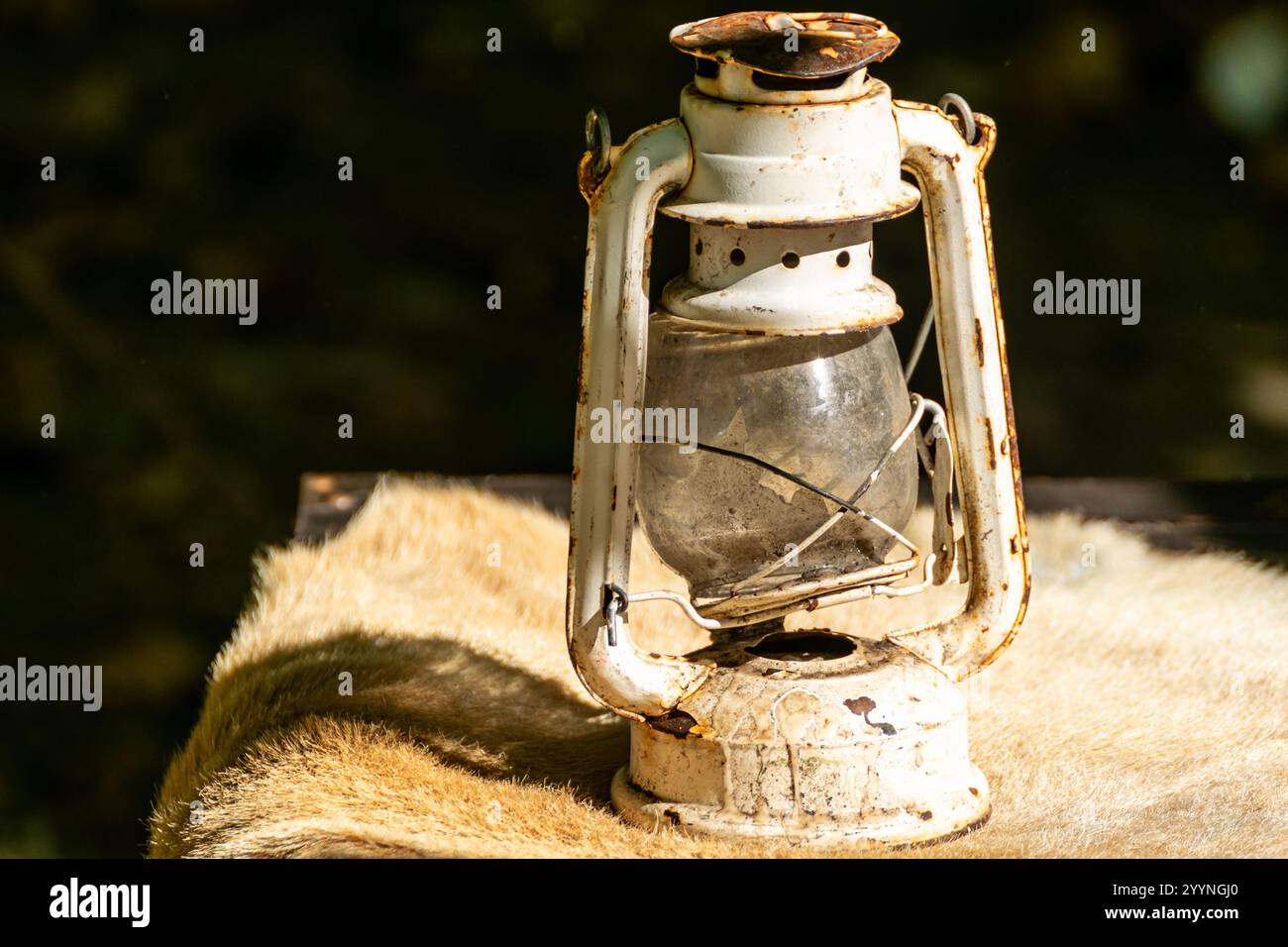 old and rusty candle on an animal skin, decoration for historical ...