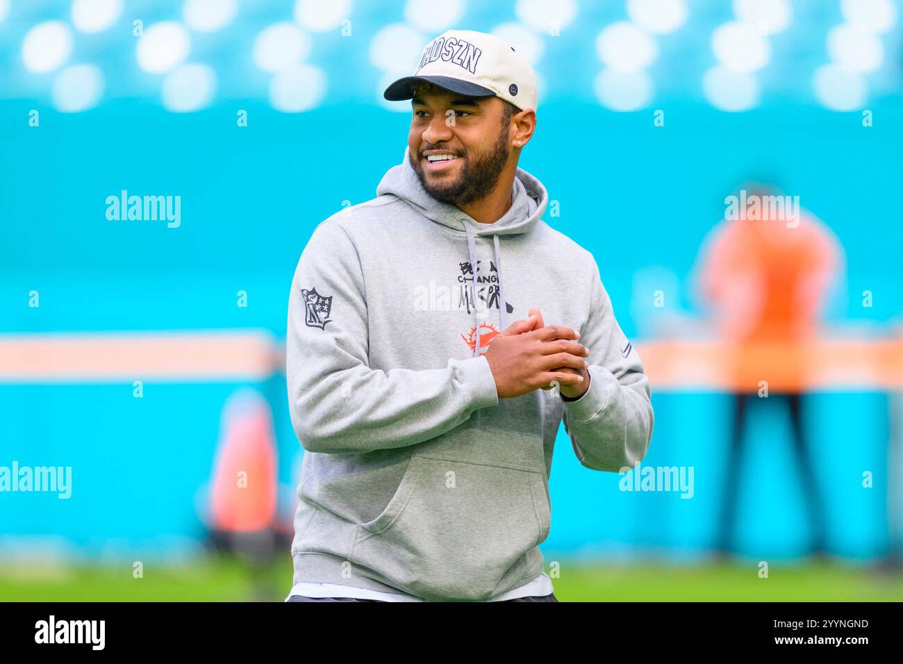 Miami Dolphins quarterback Tua Tagovailoa (1) smiles as he runs a drill ...