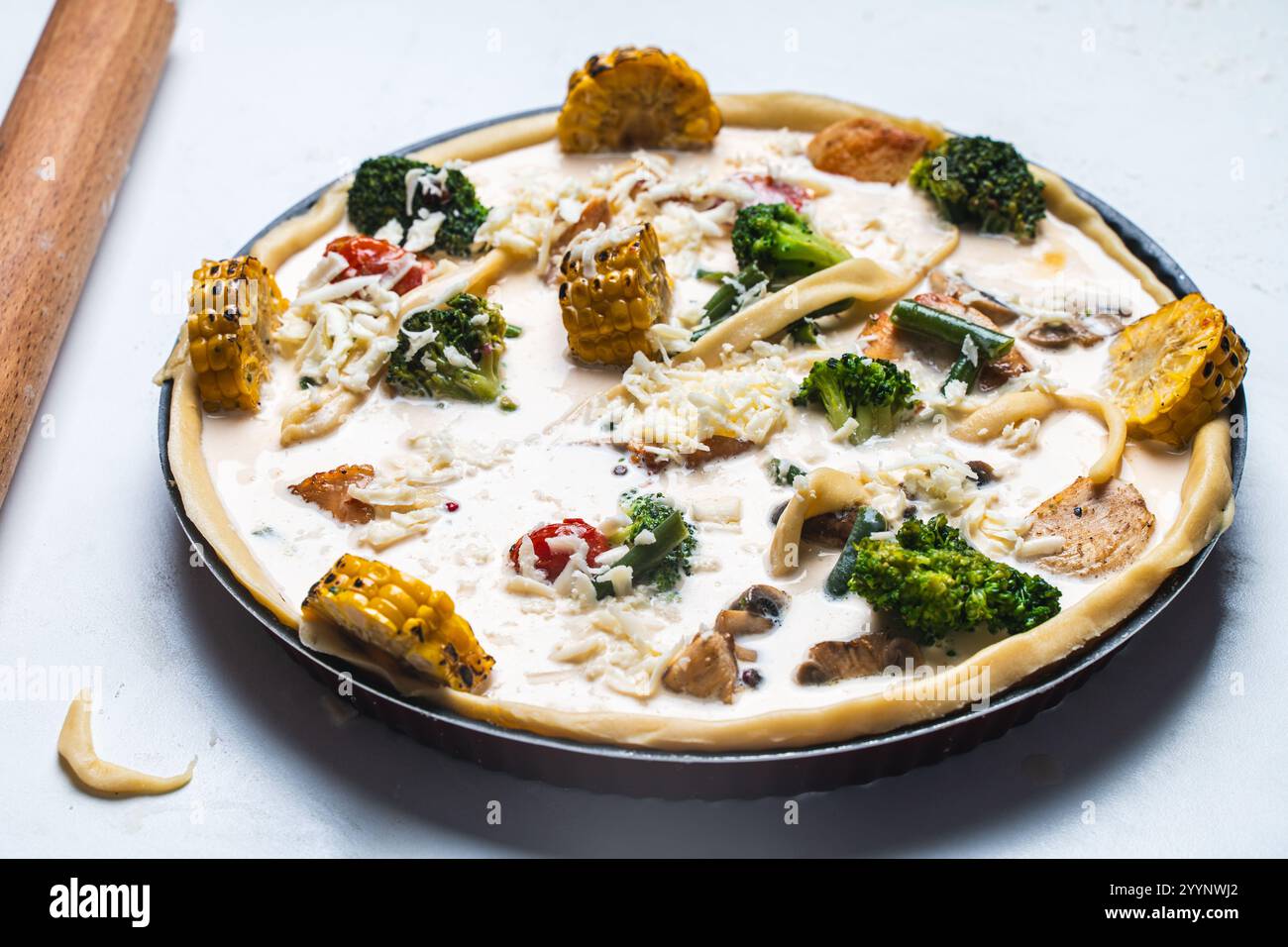 Raw Quiche with broccoli, corn, chicken and tomatoes is ready to bake ...