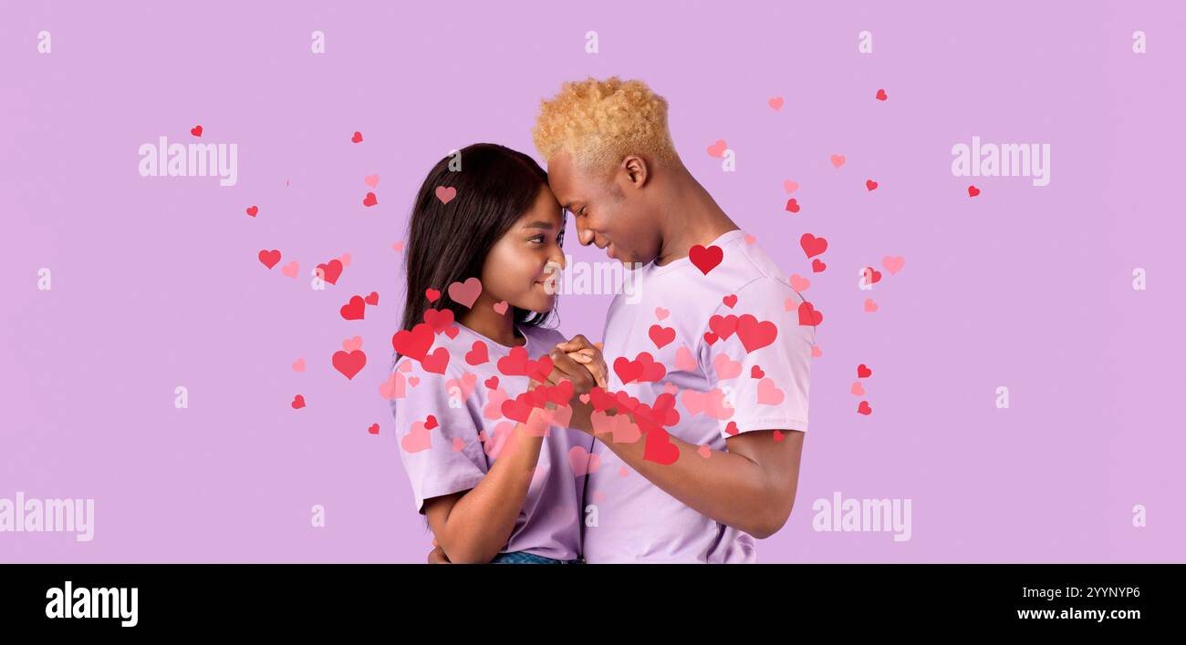 Couple sharing a romantic kiss on Valentines Day surrounded by hearts ...