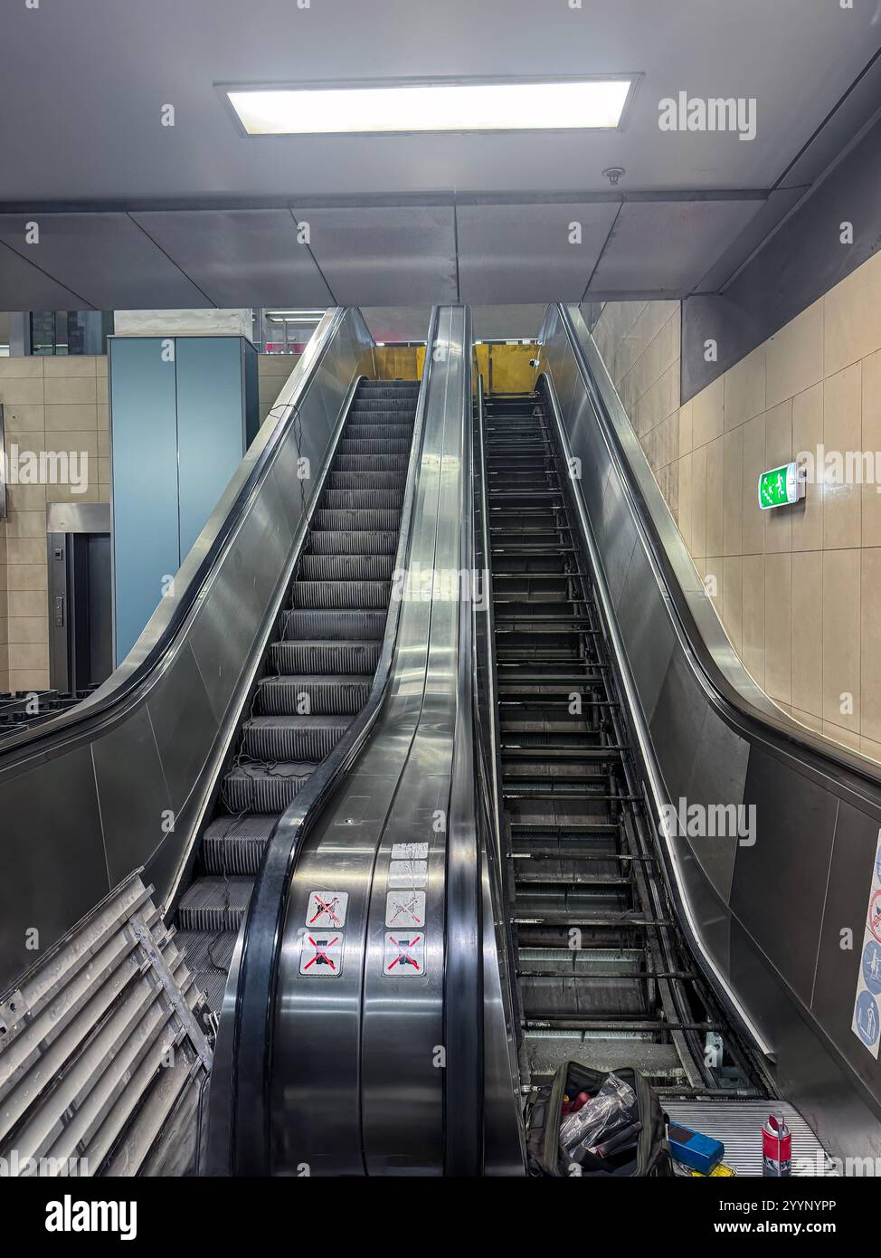 An indoor escalator in a subway or mall undergoing maintenance, showing ...