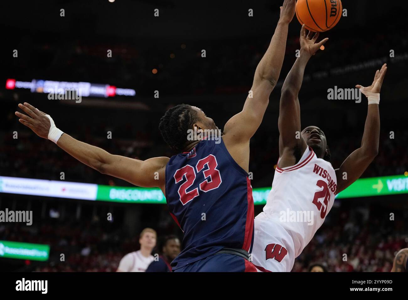 Detroit Mercy's Stephen Okoro fouls Wisconsin's John Blackwell during ...