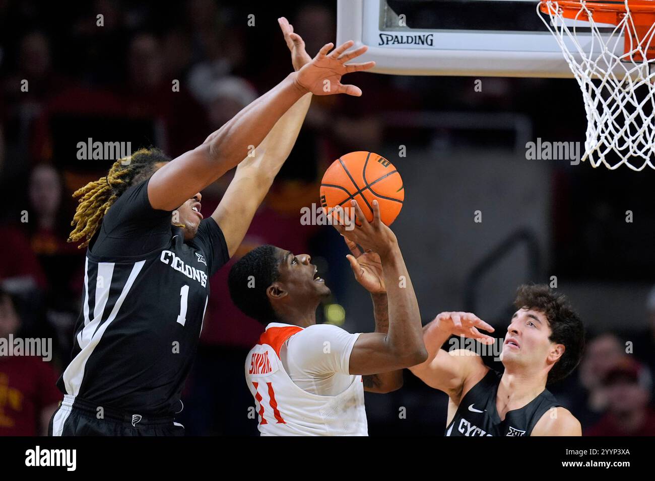 Morgan State guard Amahrie Simpkins, center, shoots between Iowa State ...
