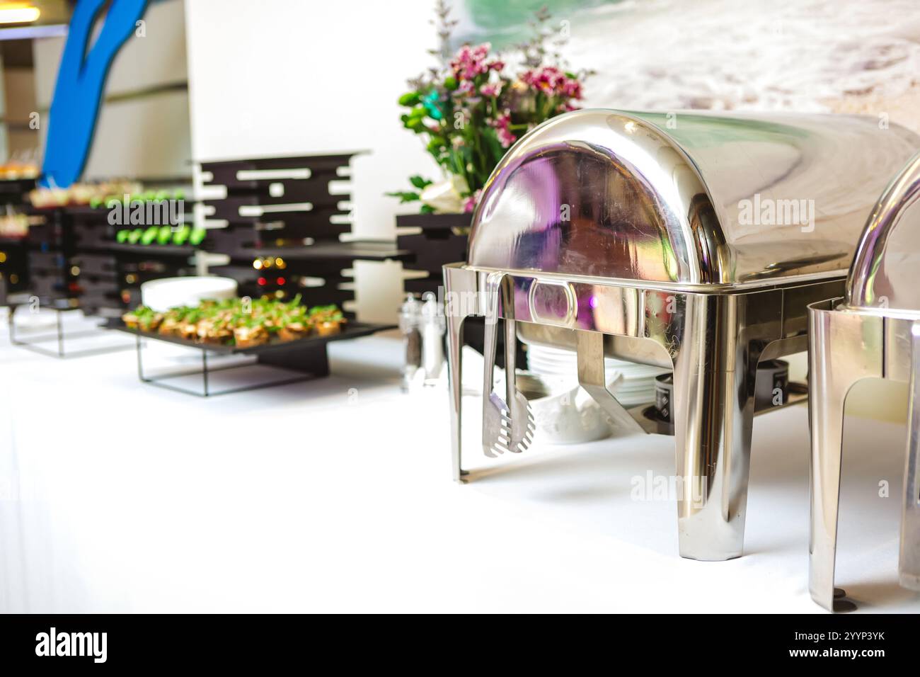 A contemporary hotel dining area featuring a sleek buffet setup and ...