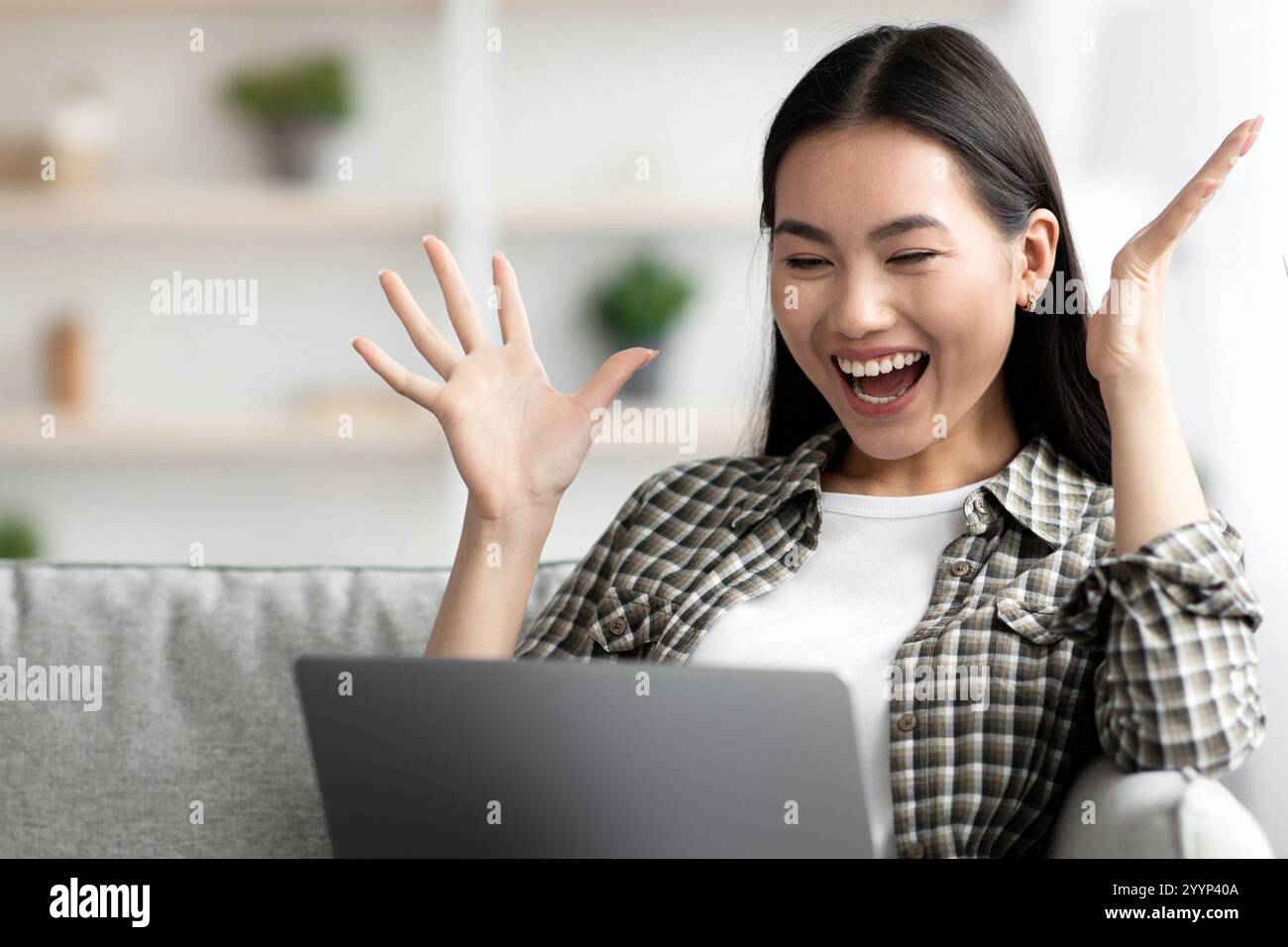 Happy asian lady screaming and raising hands up, using laptop Stock ...