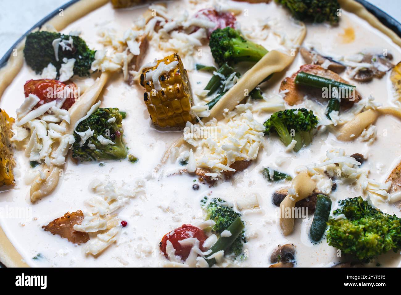 Background, Raw Quiche with broccoli, corn, chicken and tomatoes is ...