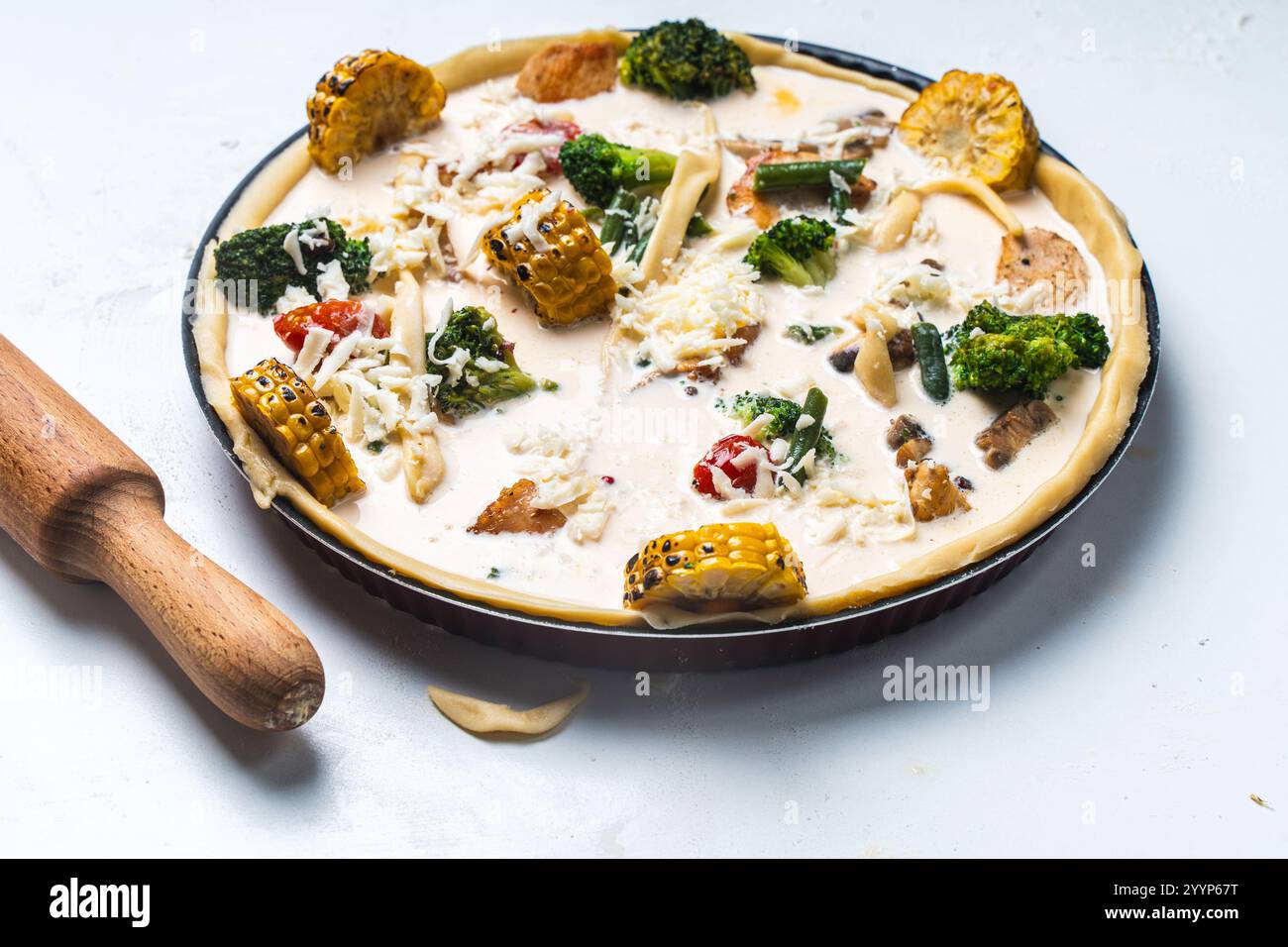Raw Quiche with broccoli, corn, chicken and tomatoes is ready to bake ...