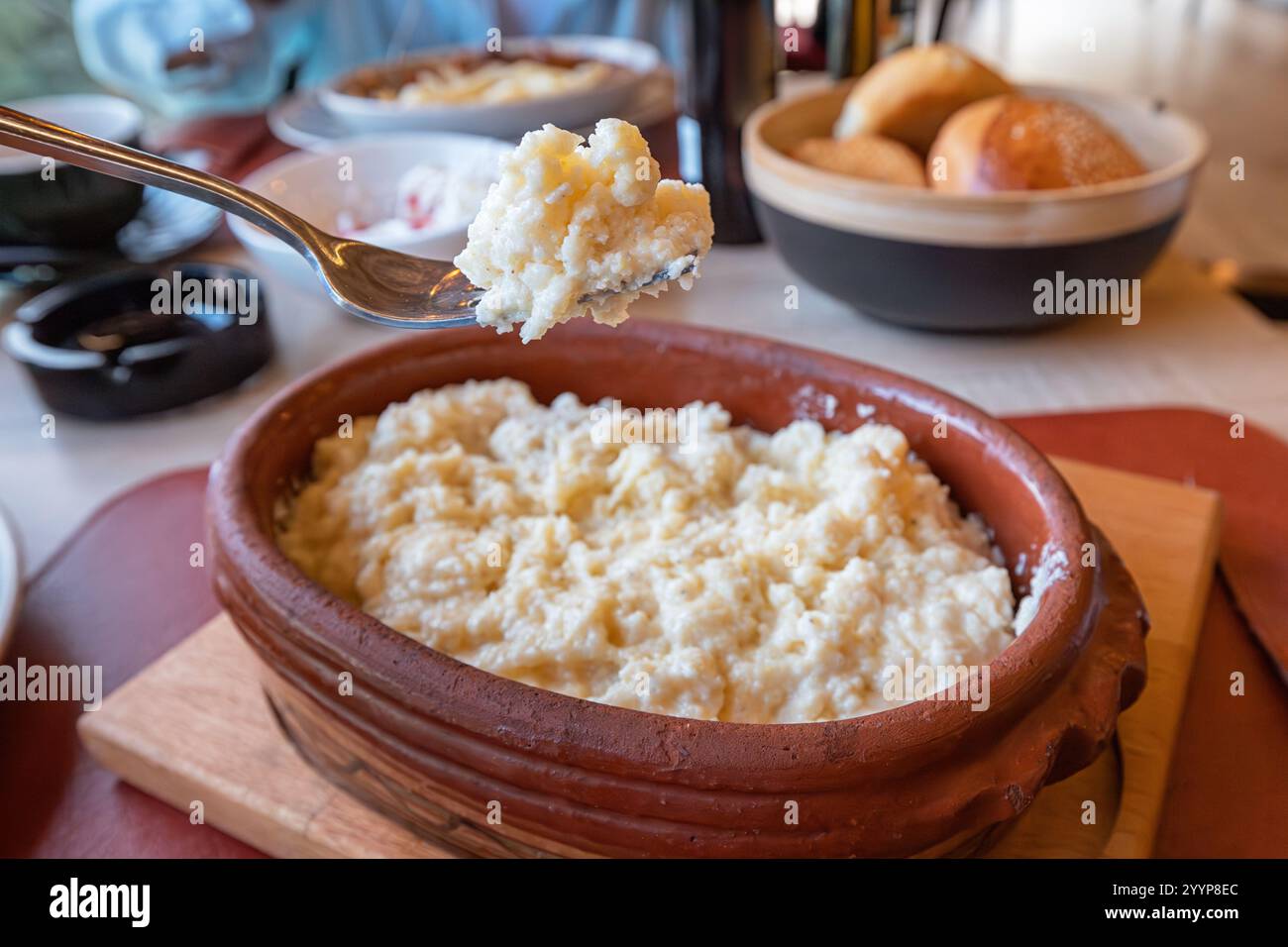 Creamy banush, a traditional romanian cornmeal dish, being served from ...