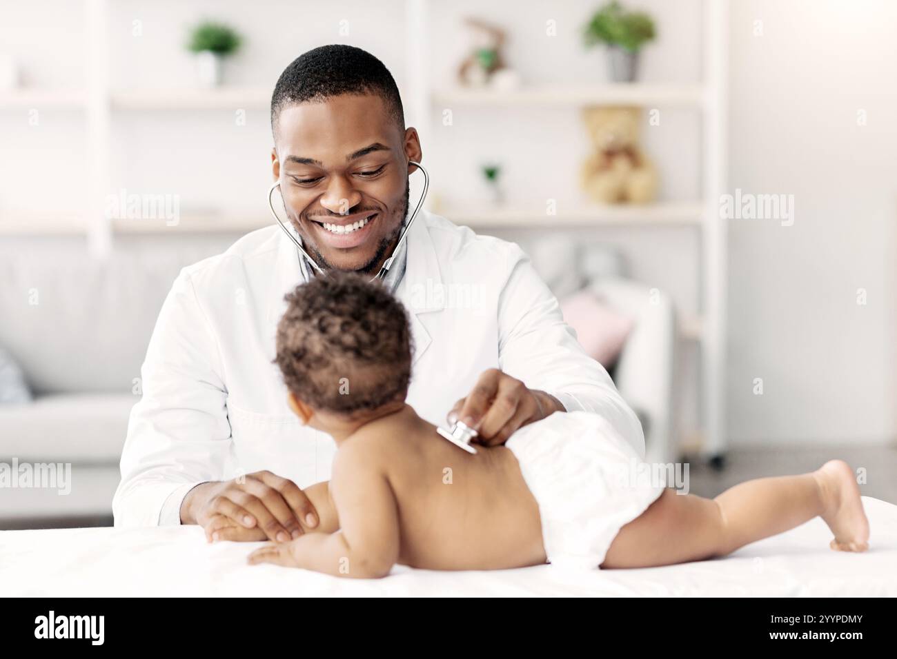 Medical Checkup. Smiling Black Pediatrician Doctor Examining Little ...