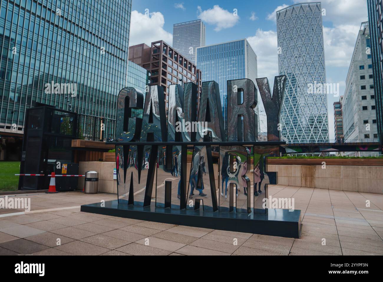 The iconic Canary Wharf sign is set against modern skyscrapers ...