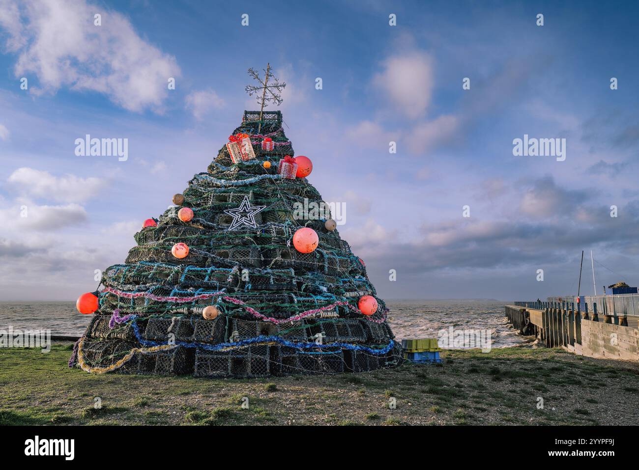 Christmas tree on a beach near the harbour in Whitstable, Kent, UK made ...