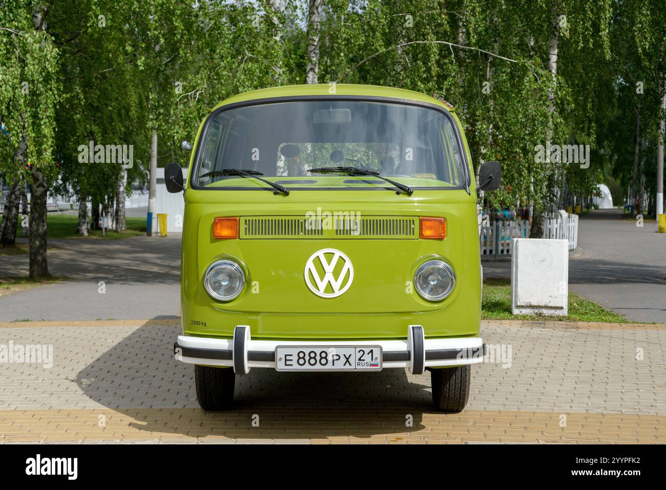 Front view of a green retro Volkswagen Kombi bus (T2) parked on tiles ...