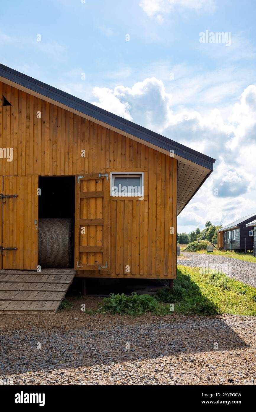 Stacked bales of hay lie in storage in barn. Rural organic nature farm ...