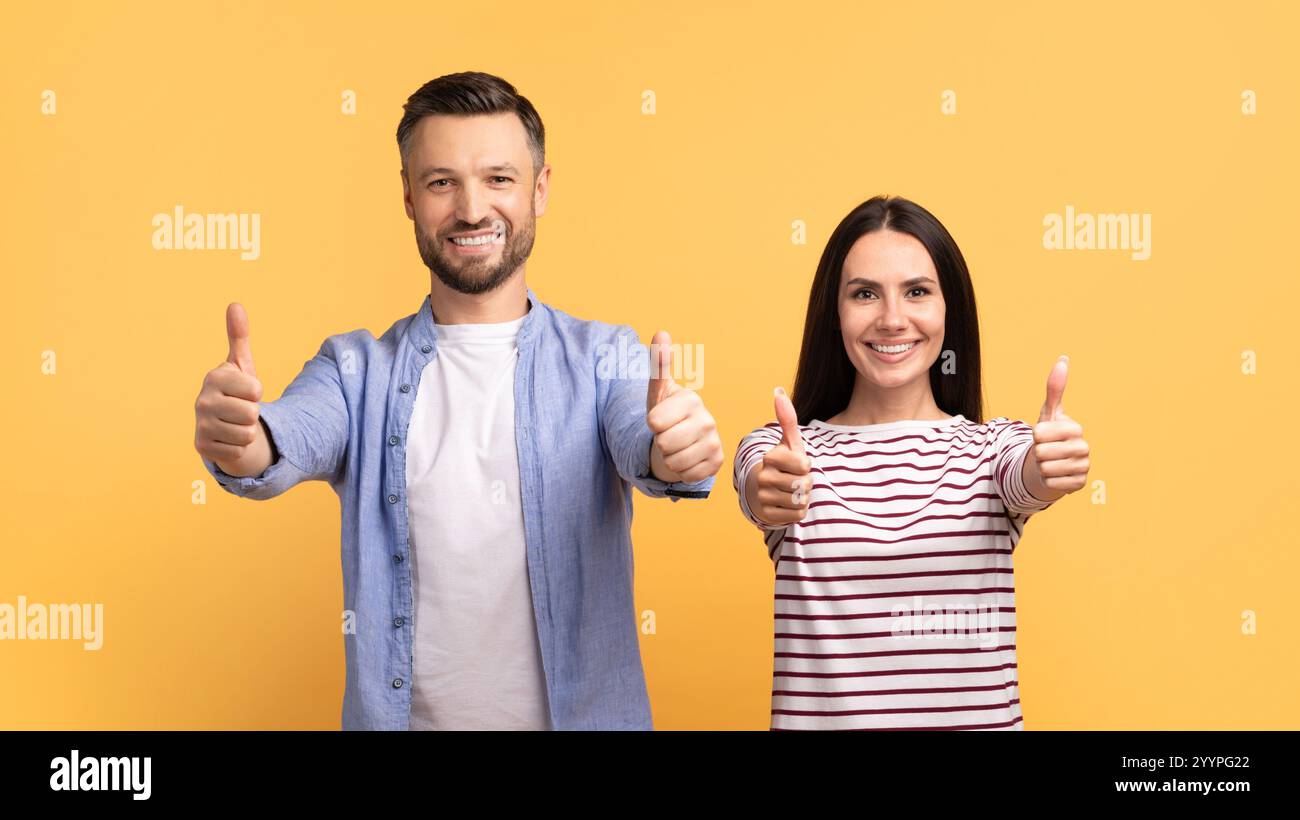 Couple expressing love and affection with thumbs up in bright setting ...