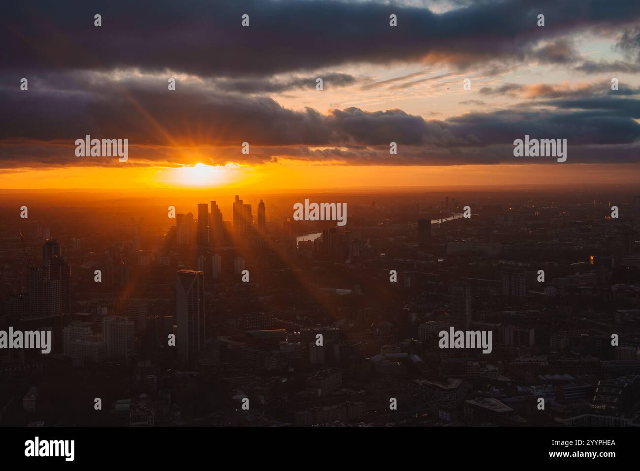 The image shows a sunset over London, highlighting skyscrapers and the ...