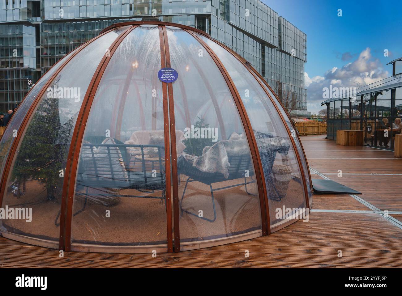 A transparent igloo style dome on a wooden deck in London features cozy ...