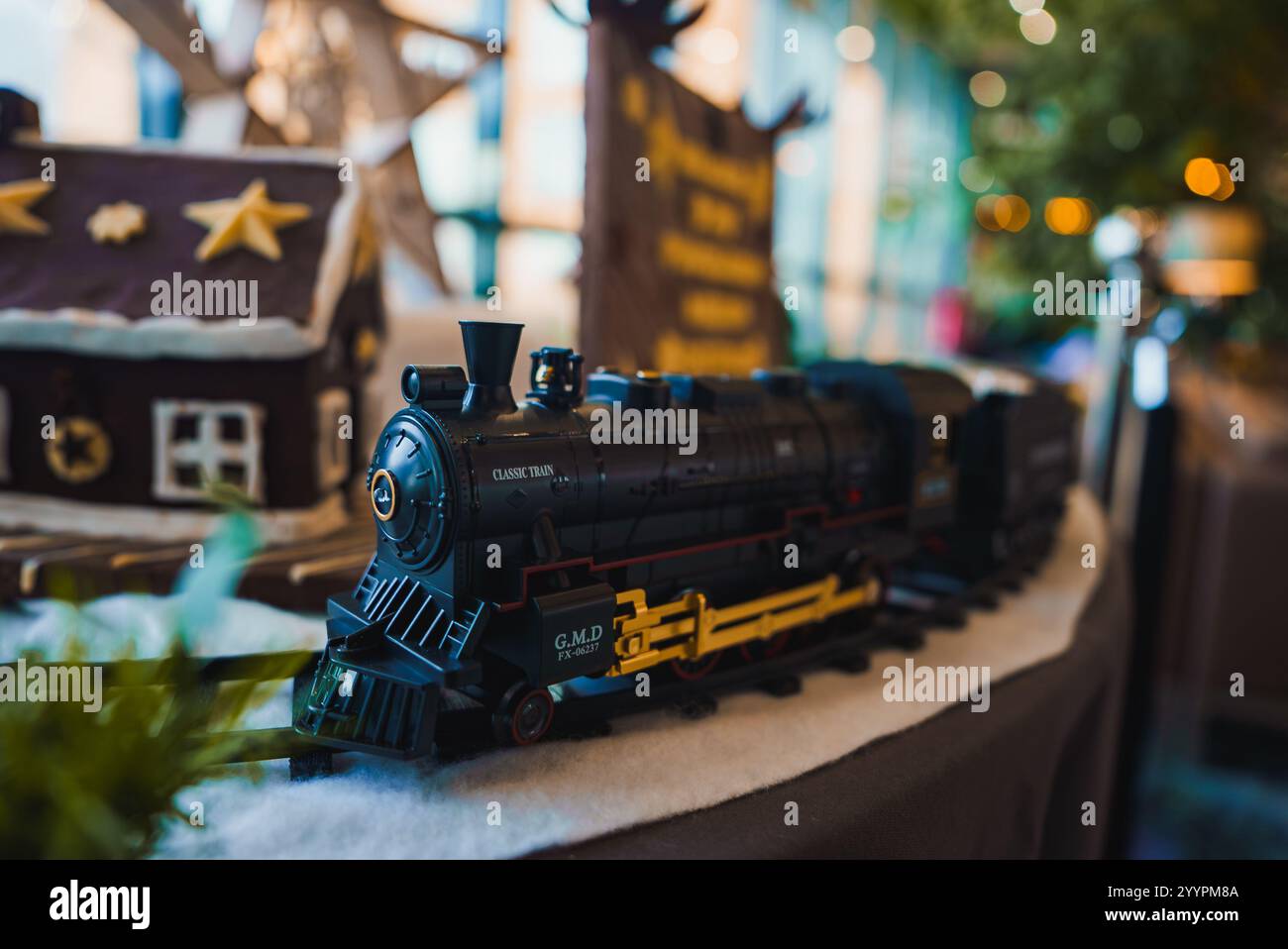 A detailed model train labeled Classic Train and G.M.D on a snowy track ...