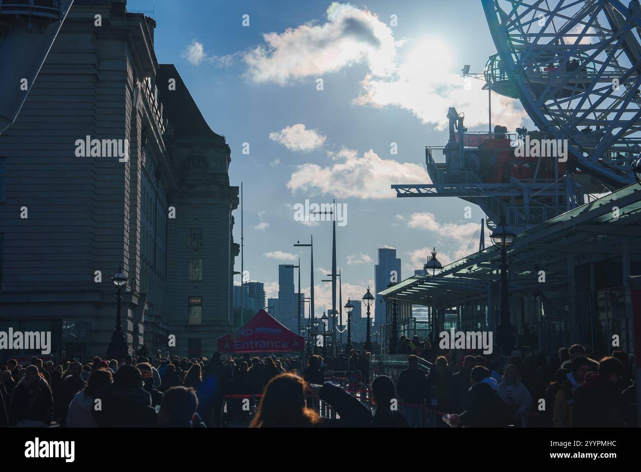 A bustling crowd gathers near the London Eye in London during Christmas ...