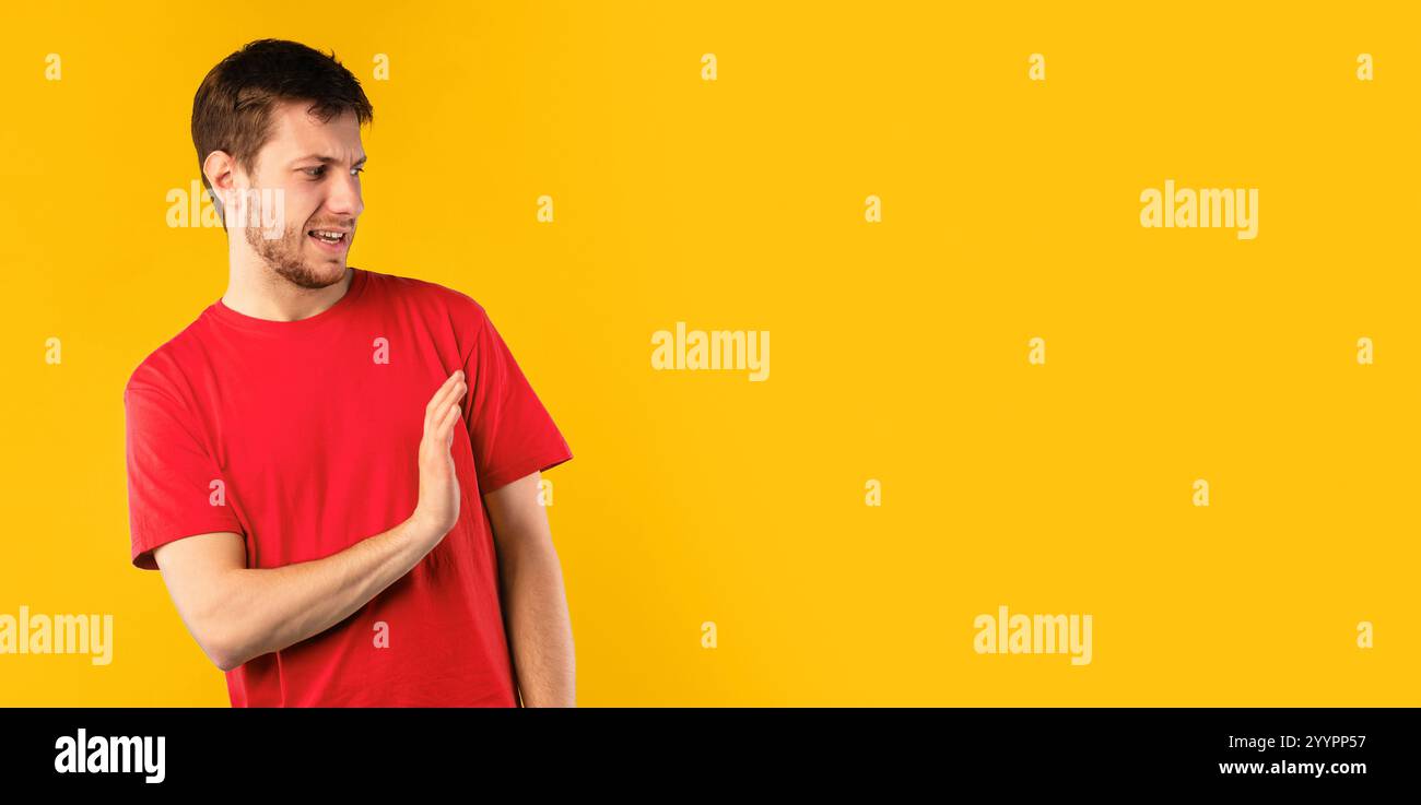 Shocked guy with disgusted face showing stop sign Stock Photo - Alamy