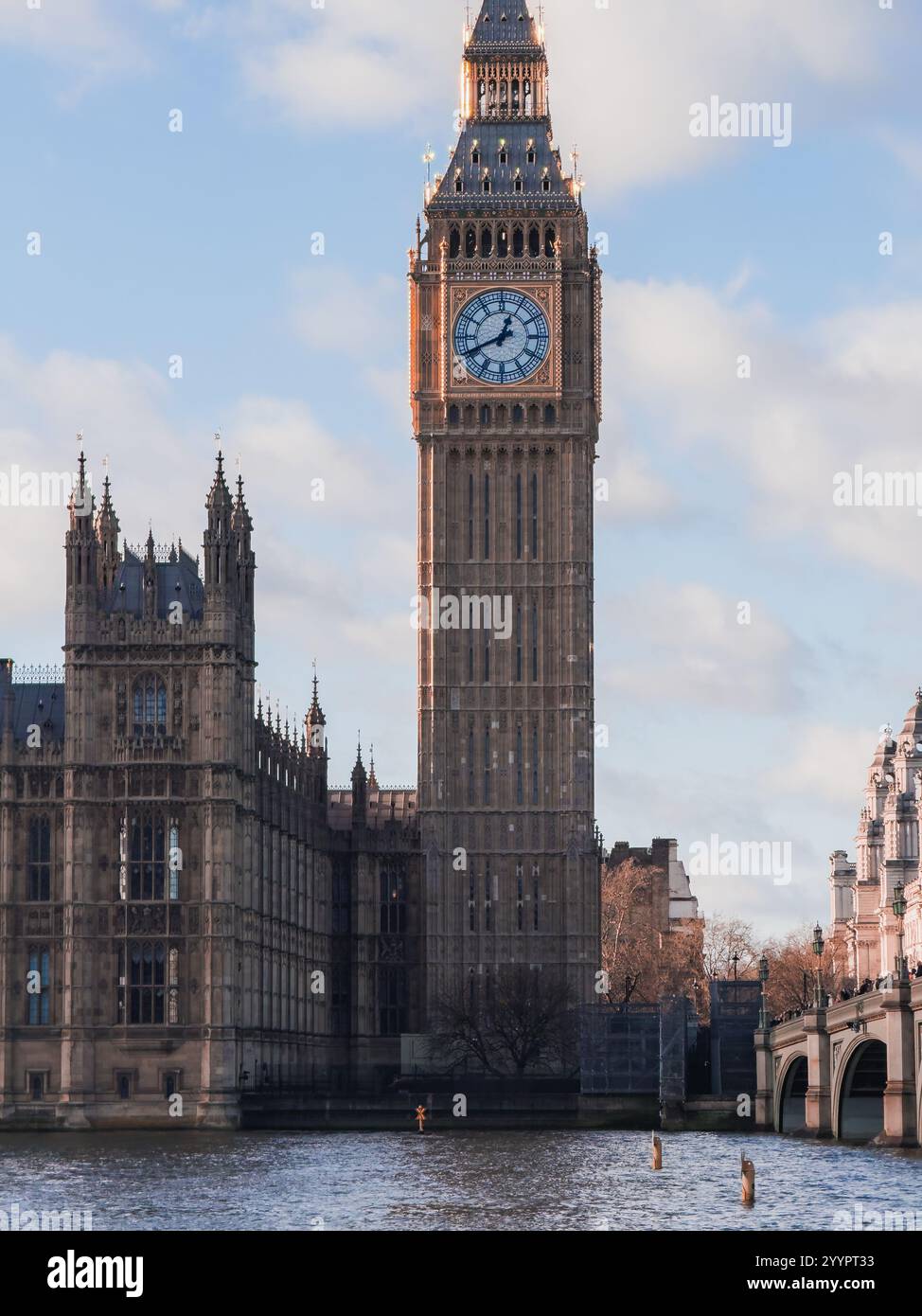 Big Ben clock tower stands tall against a partly cloudy sky, with the ...