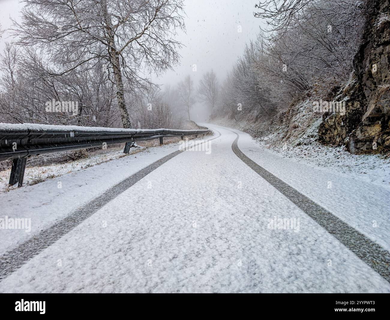 Snow on a road in winter season in the italian prealps Stock Photo - Alamy