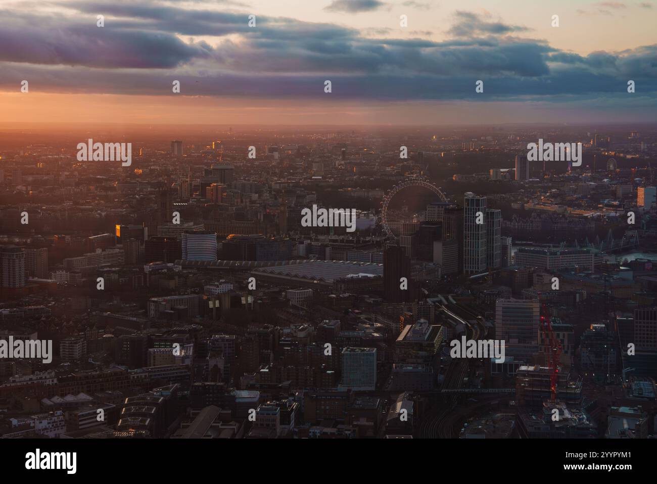 The image shows a panoramic view of London during sunset, featuring the ...