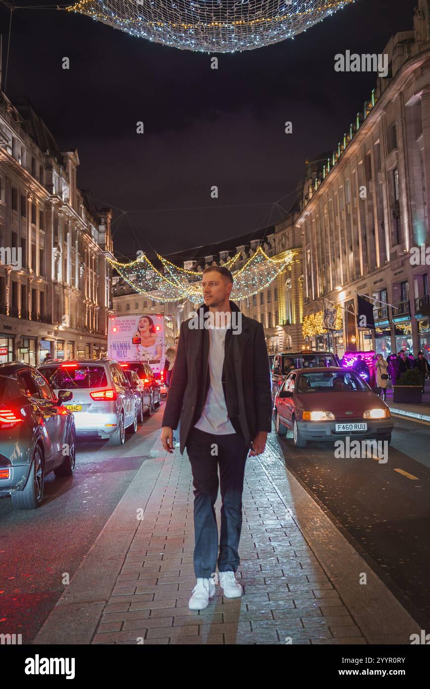 A busy London street scene during Christmas, featuring festive lights ...