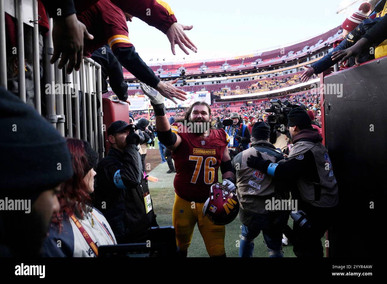 Washington Commanders guard Sam Cosmi (76) greeting fans as he heads ...