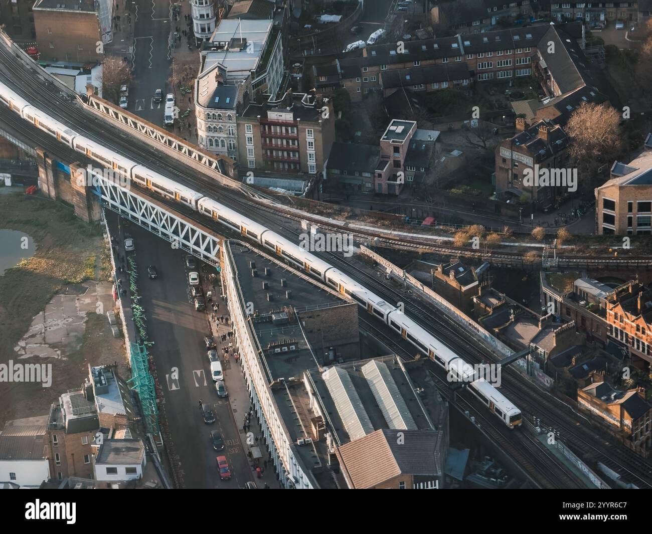An aerial perspective of a train crossing a bridge in London ...