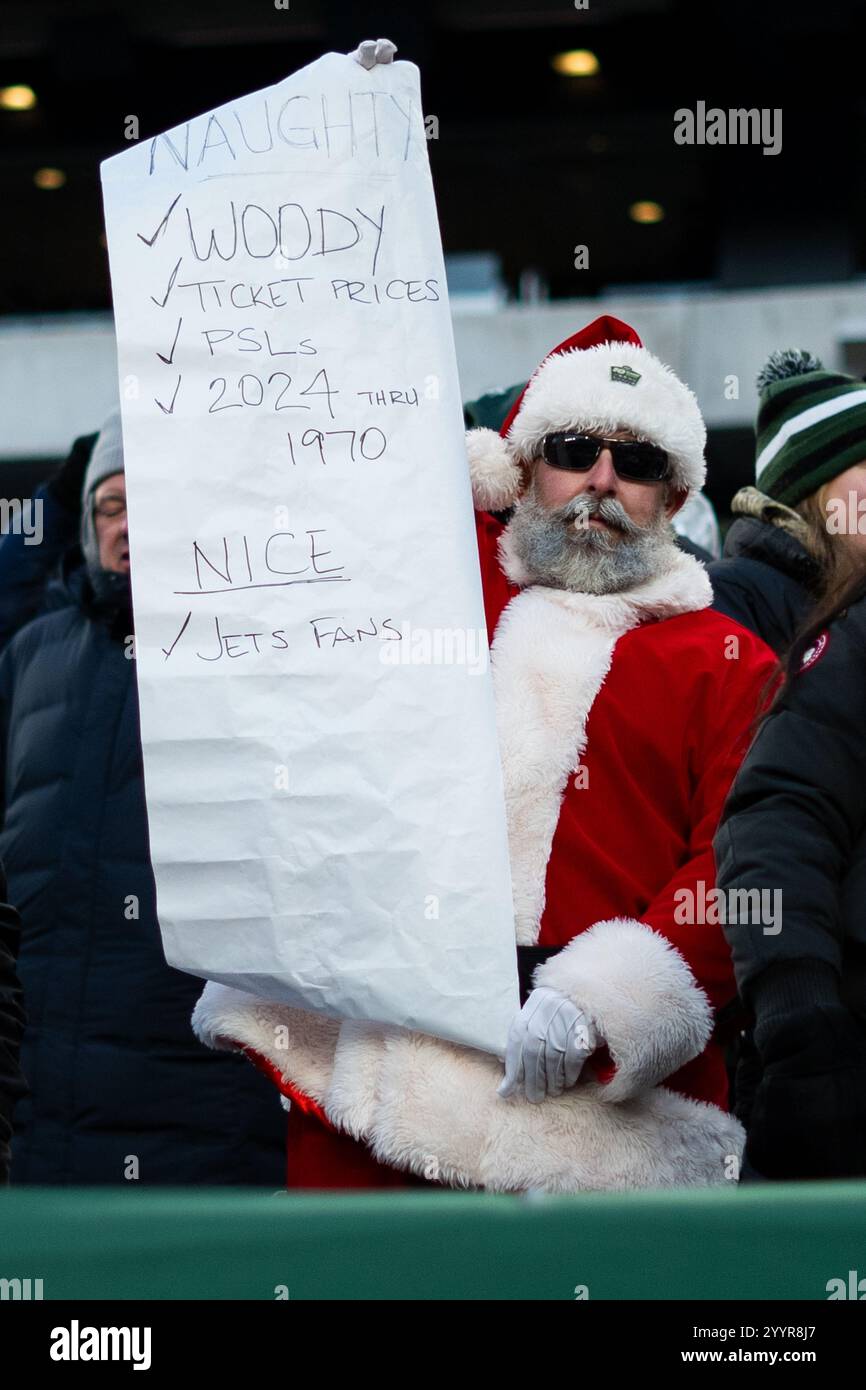 A fan dressed as Santa with his Naughty and Nice list for the New York ...