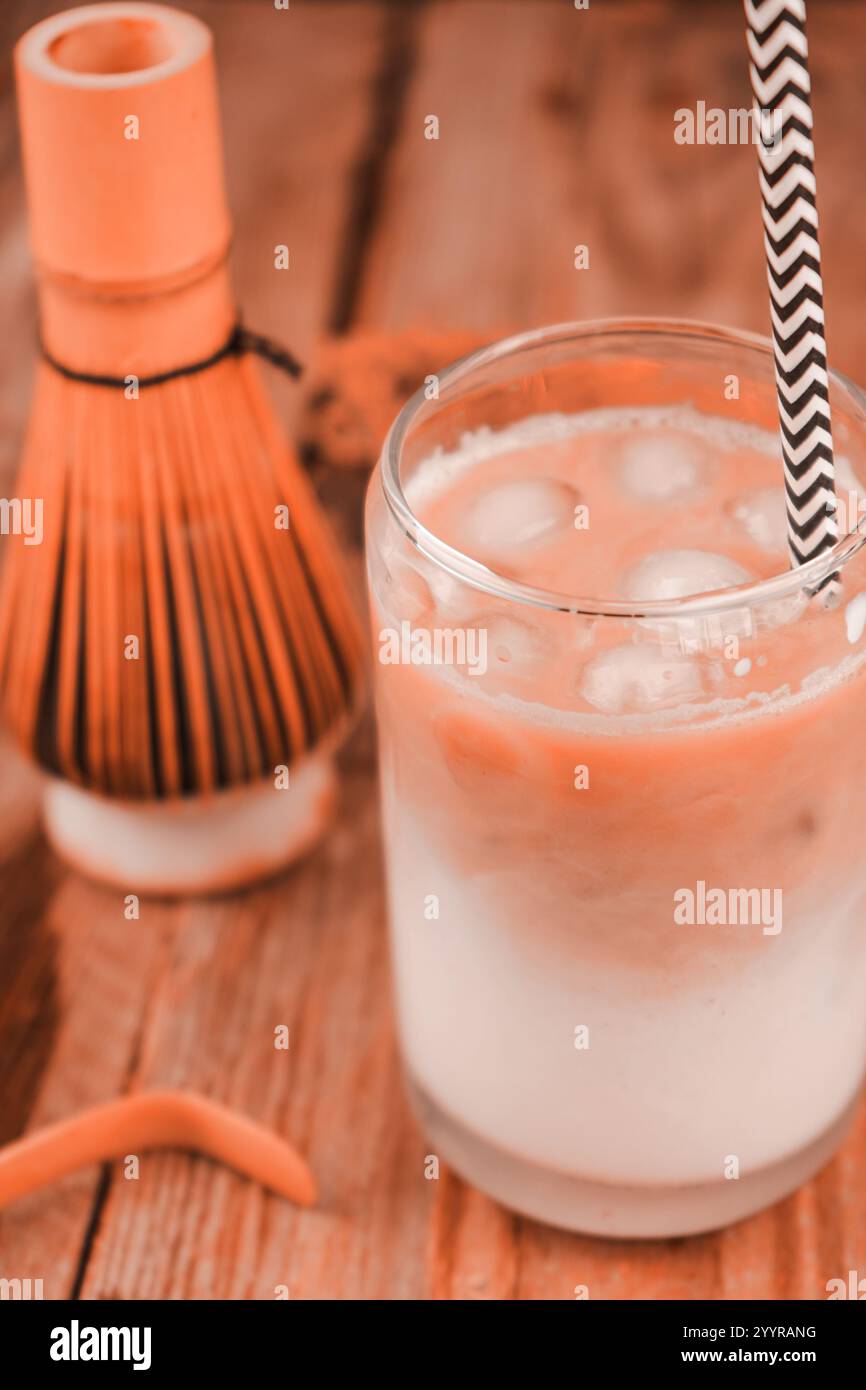 A close-up shot of a bamboo matcha whisk resting on a matcha table ...