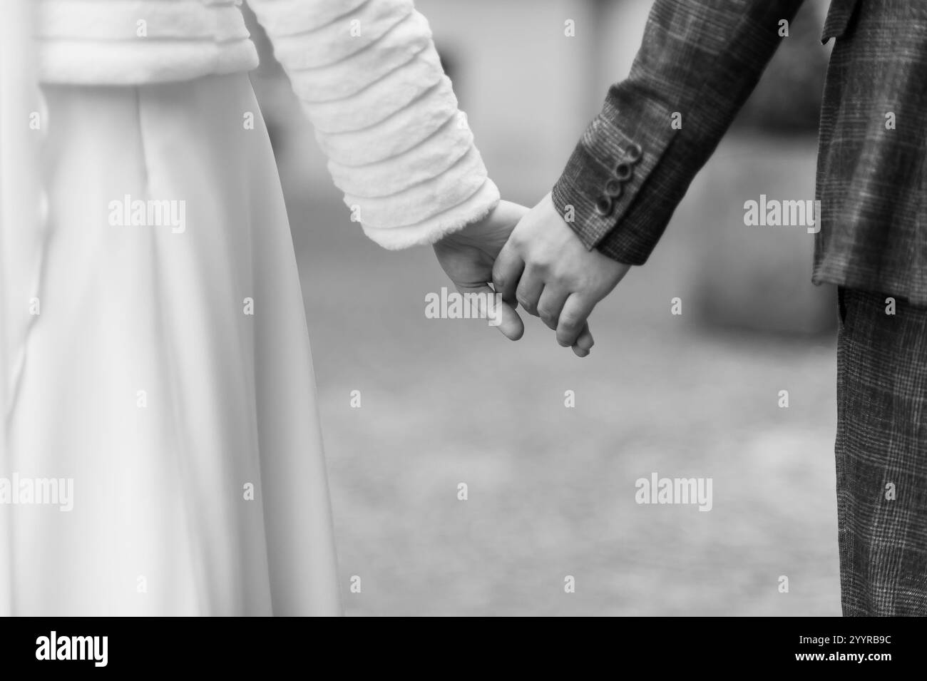 Intimate Moment Between a Couple Holding Hands in Black and White Stock Photo - Alamy
