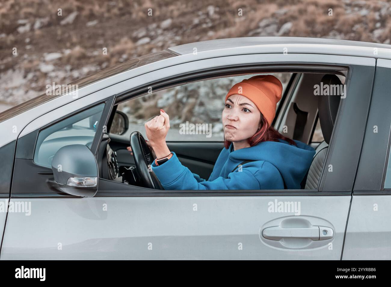 Angry female driver shaking fist at another car while driving Stock ...
