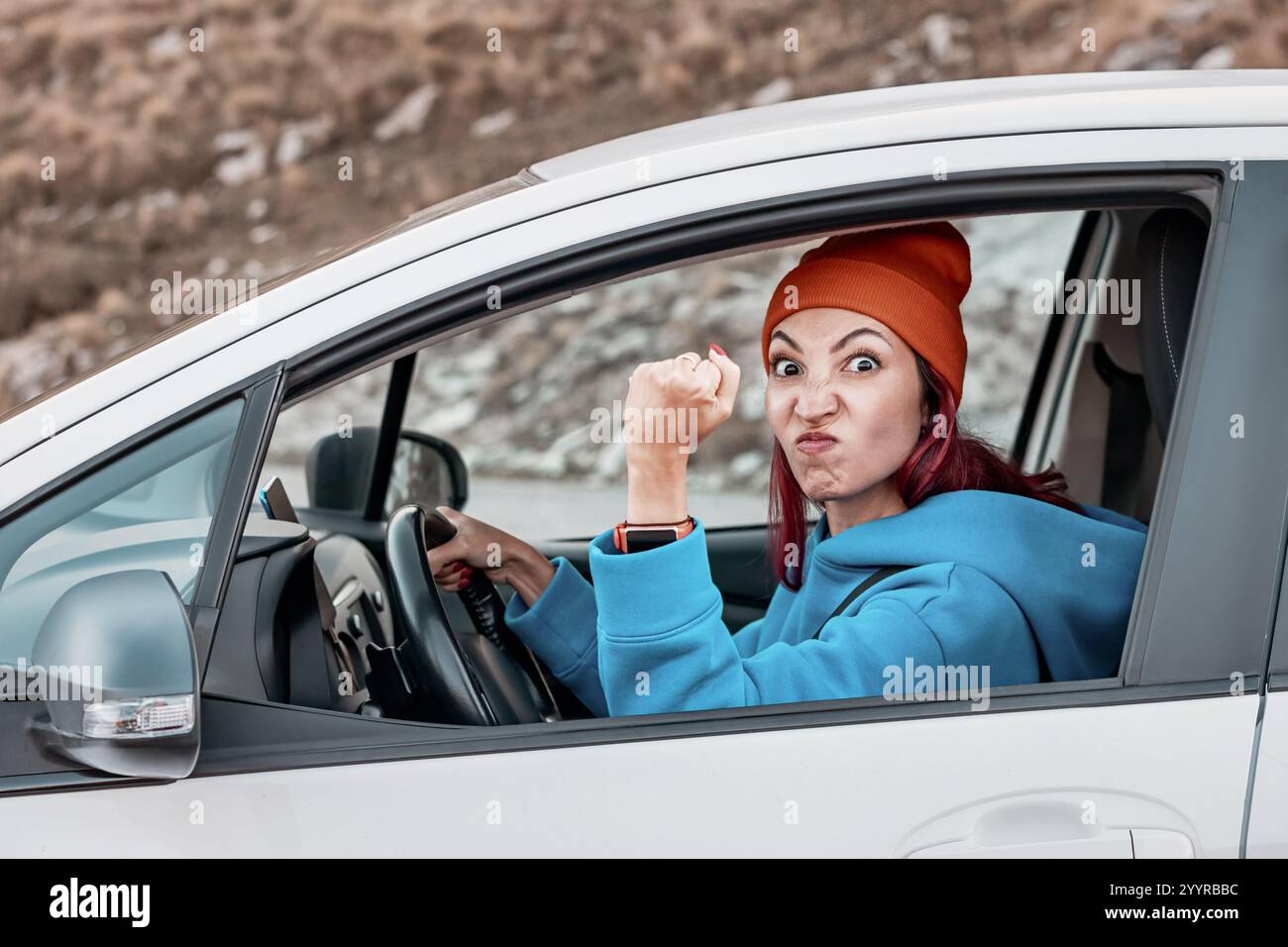 Angry female driver shaking fist at another car while driving Stock ...