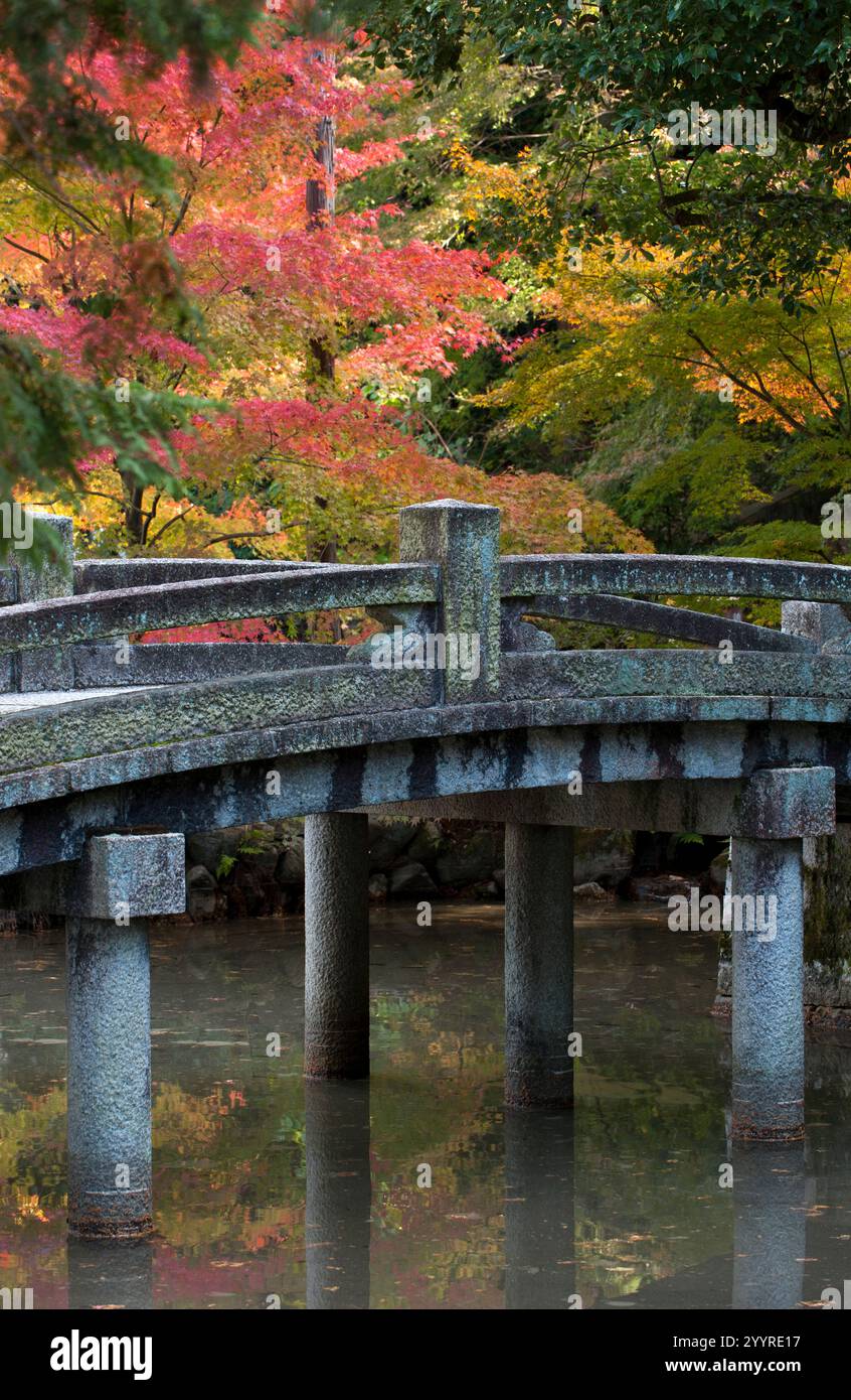 Arched stone bridge leading to the Chionin Nokotsudo temple pavilion at ...