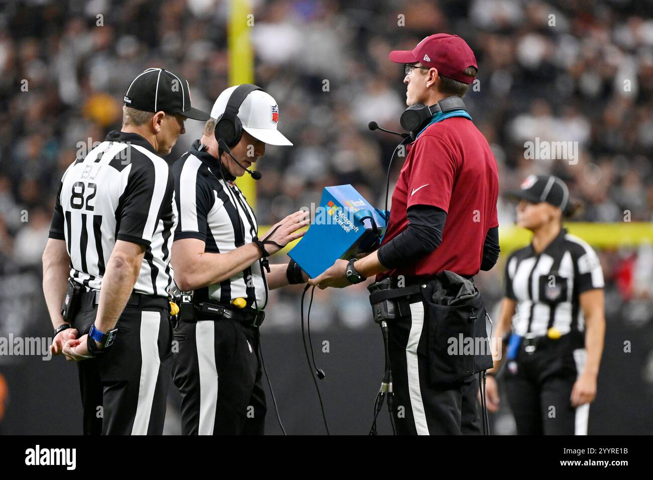 Referee Shawn Hochuli, center, reviews a play as back judge Jimmy ...