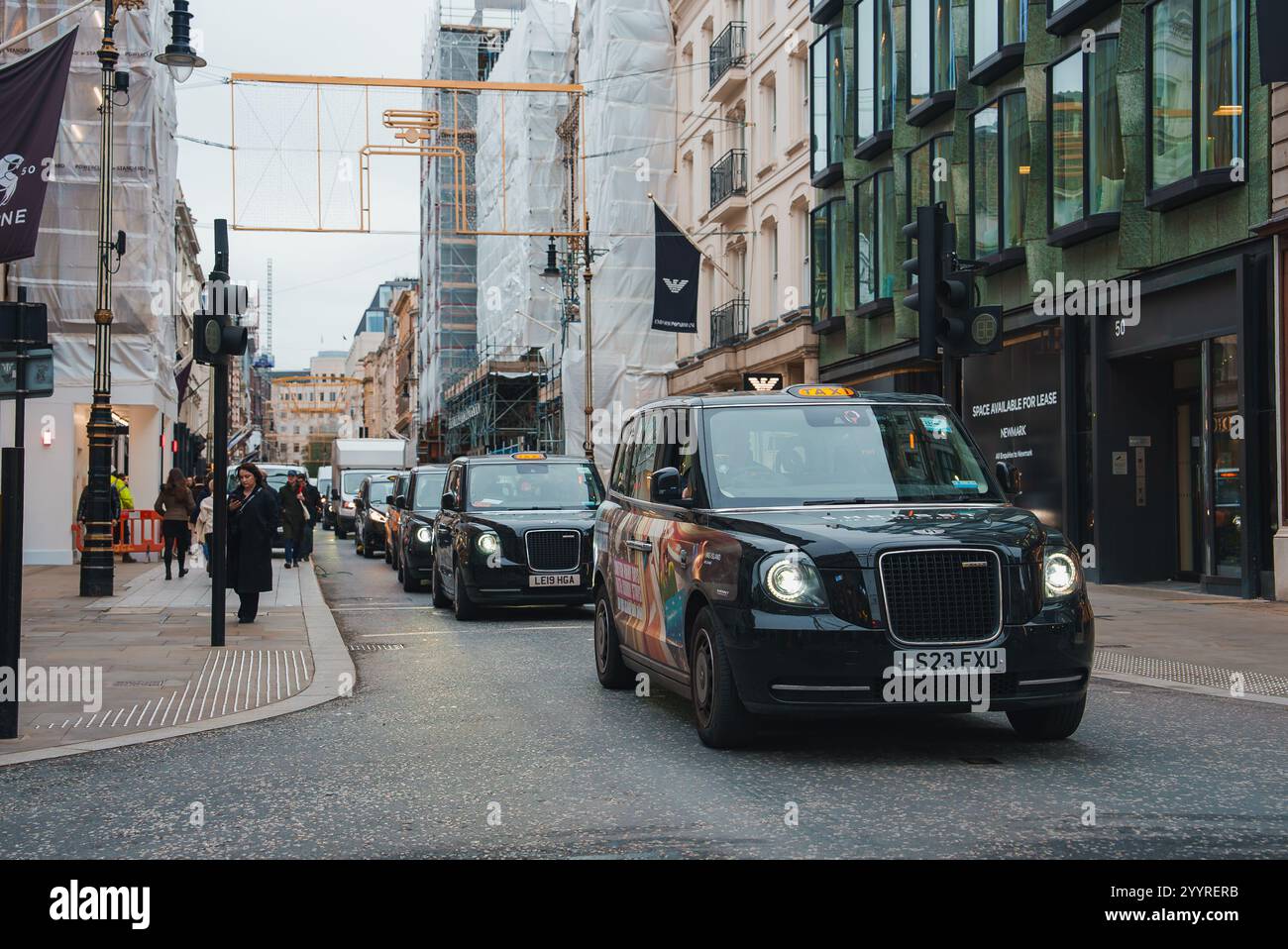 Bustling London Street Scene with Black Cabs and Christmas Lights Stock ...