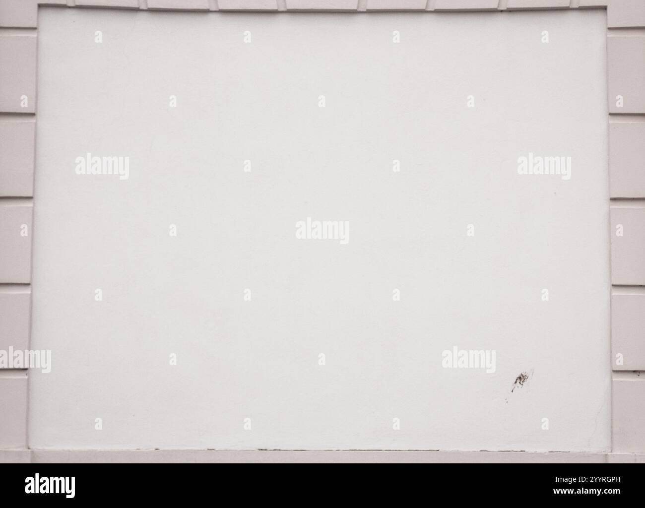 pantone 2025. White wall of a building with bricks along the perimeter ...