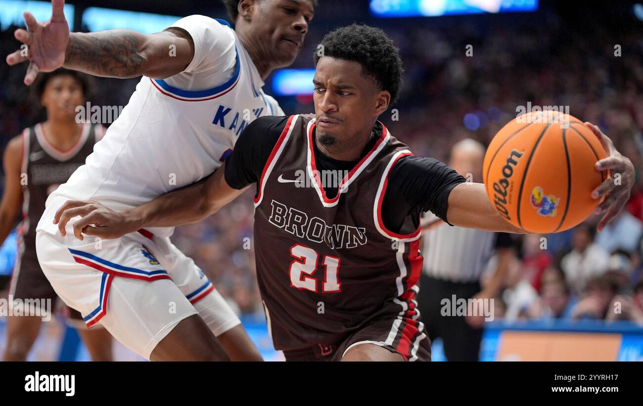 Brown guard Aaron Cooley (21) drives under pressure from Kansas guard AJ Storr during the second ...