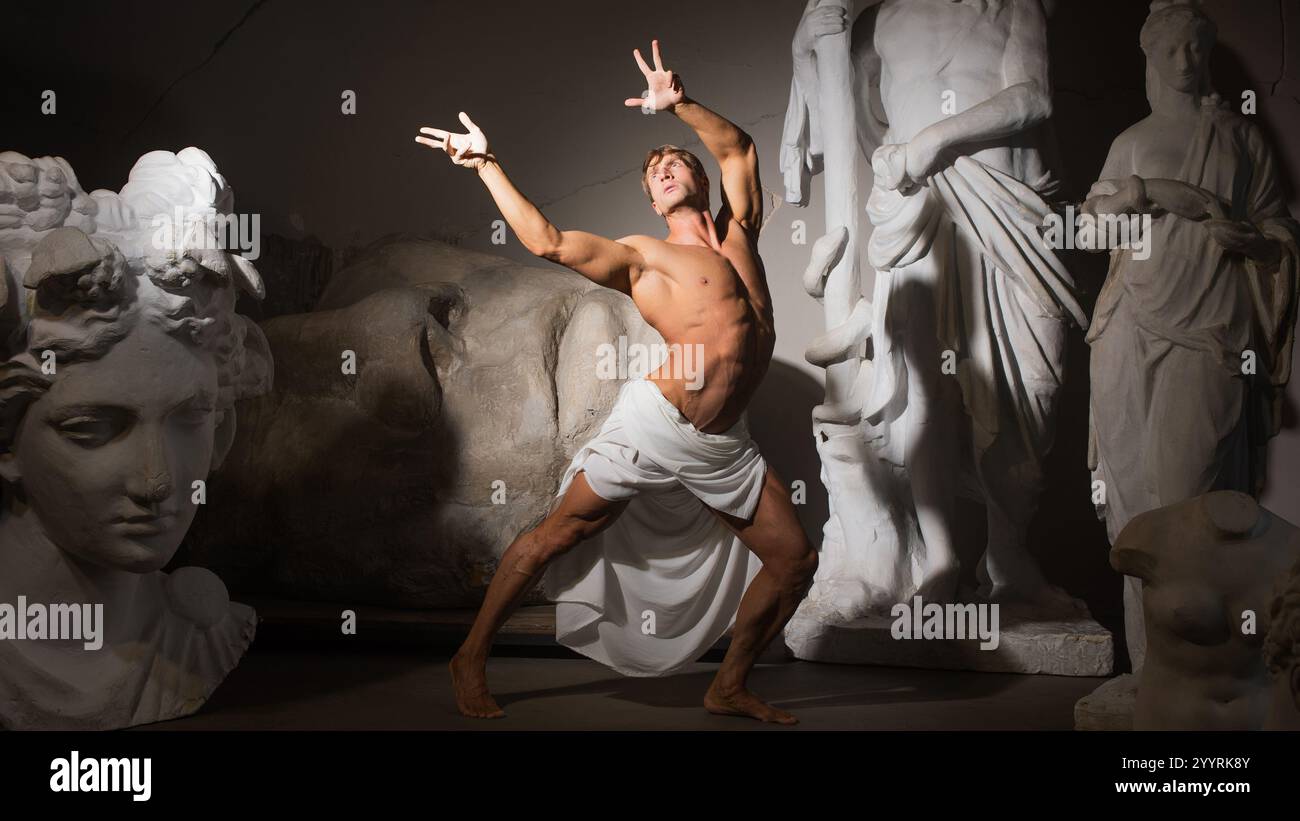 A sculptor's workshop, a muscular man in a tunic among antique statues ...