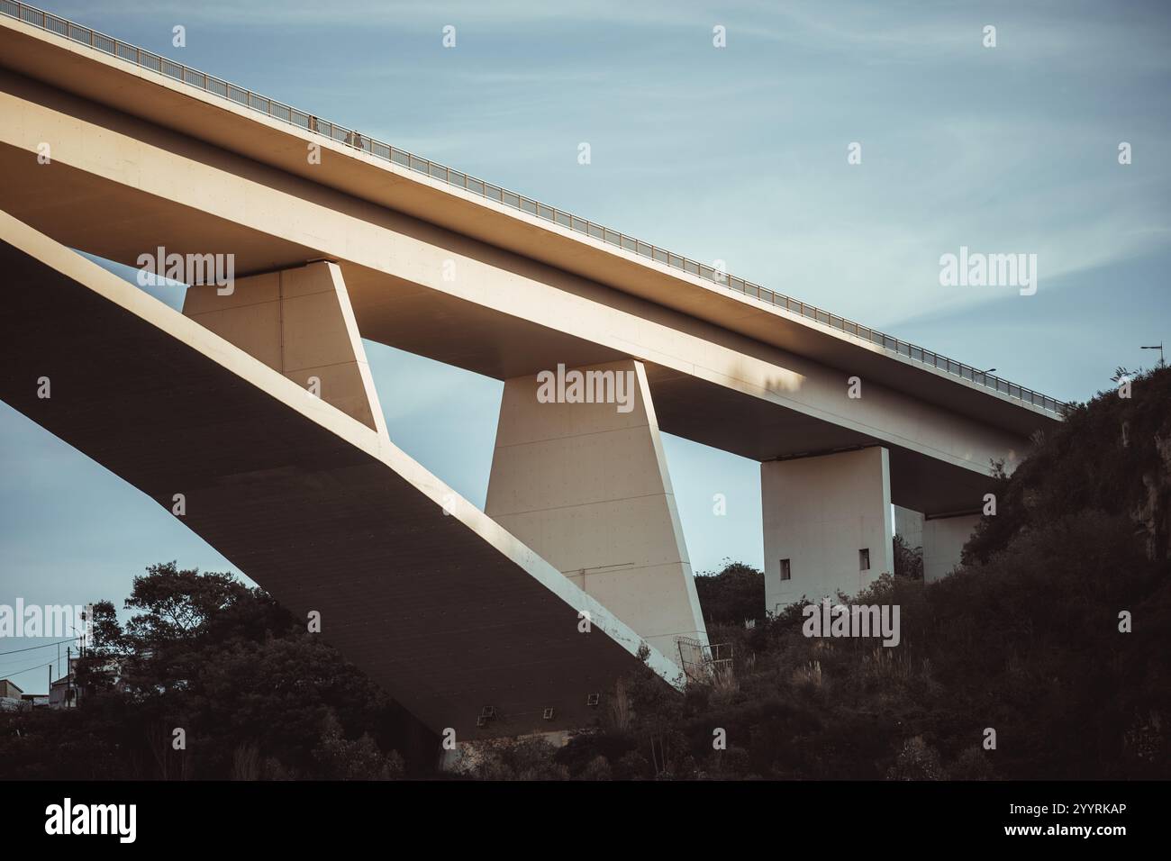 A large modern concrete bridge with minimalistic design, supported by ...