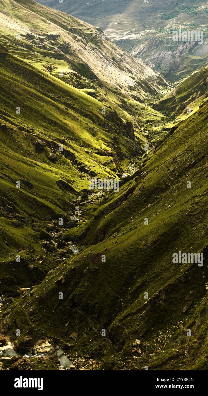 An epic view of a huge mountain rift, the terrain is covered with ...