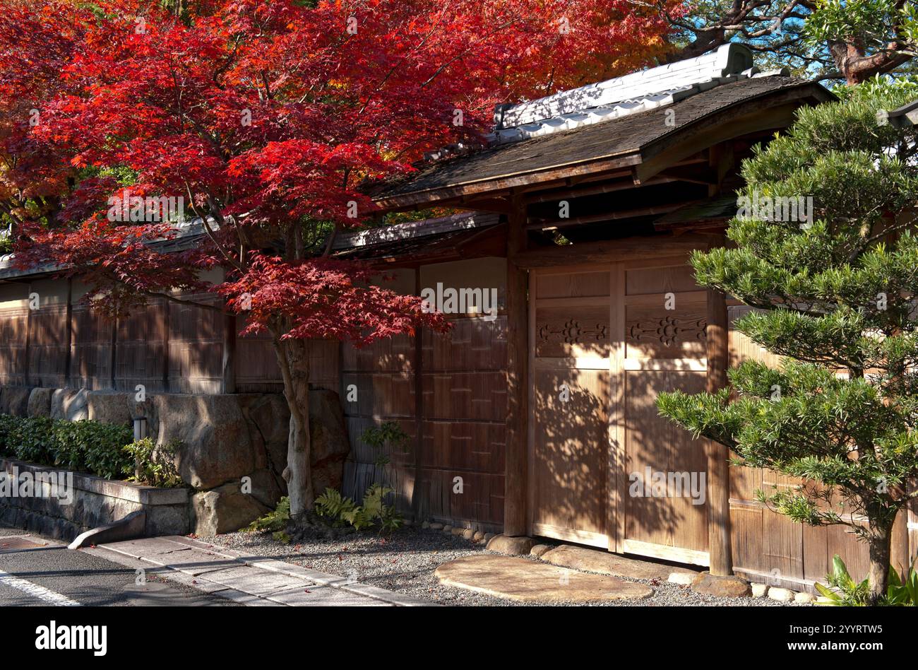 A gate at a wealthy Japanese residence features traditional Japanese ...