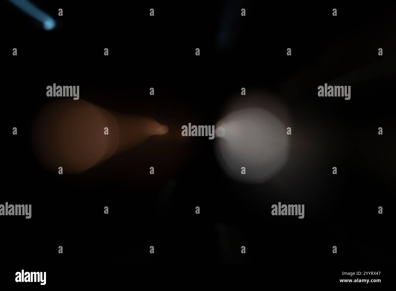 Bright light beams pierce through darkness, creating a dynamic ...