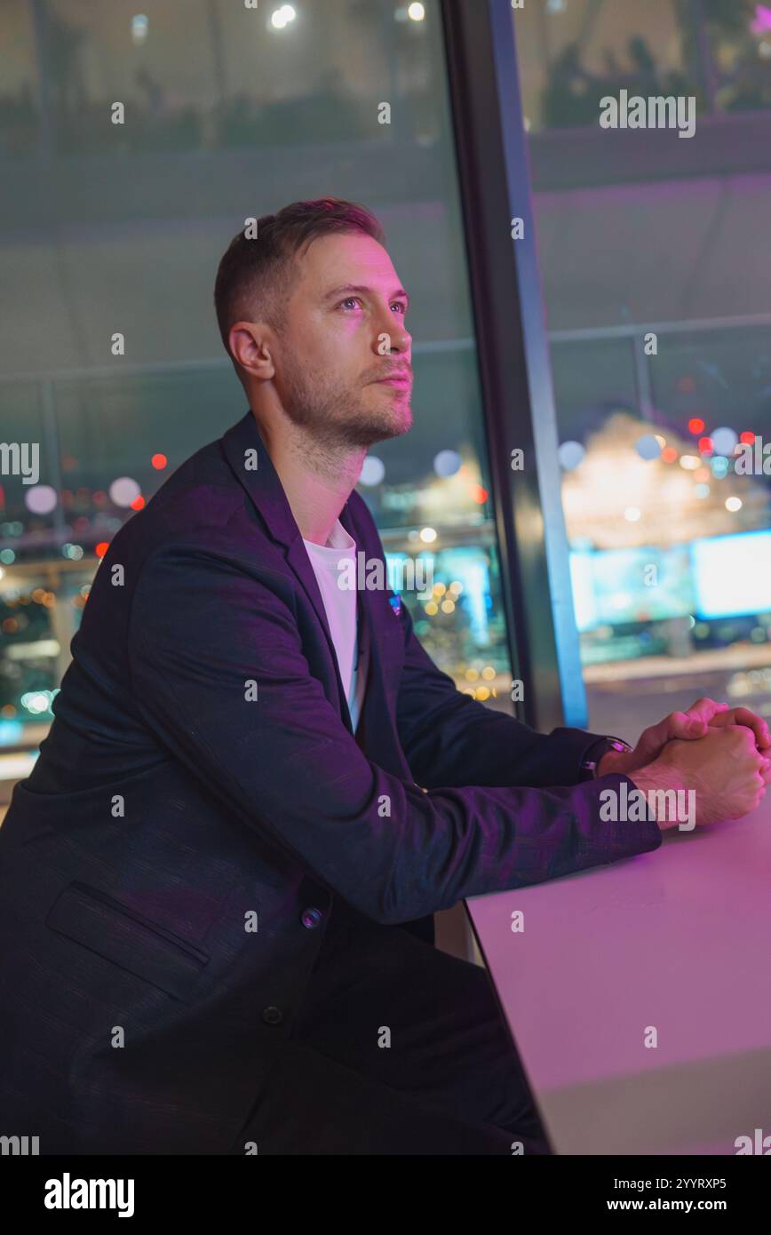 Man in Smart Casual Attire Gazing Out Window in Urban Setting Stock ...