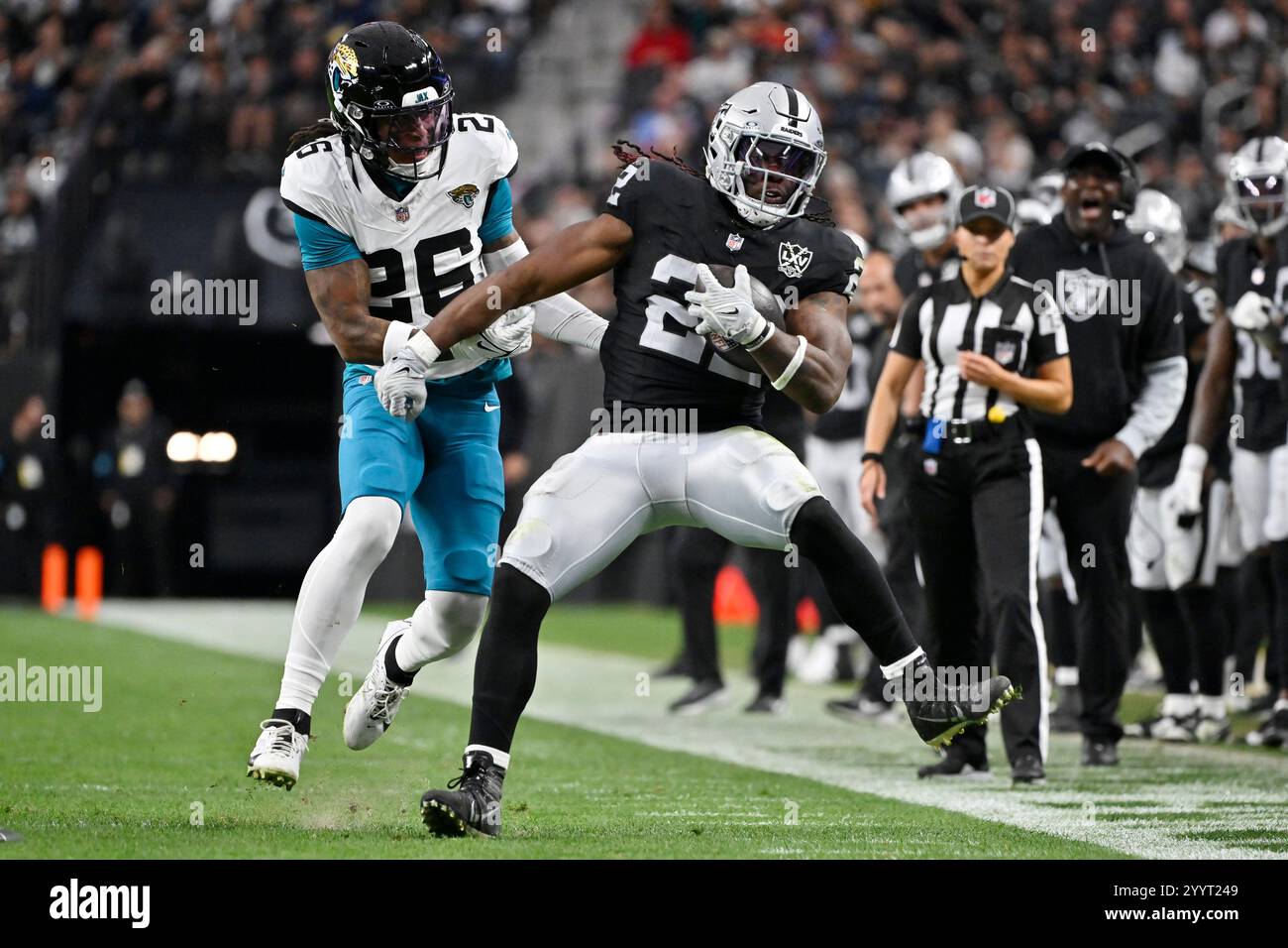 Las Vegas Raiders running back Alexander Mattison, right, tries to spin ...
