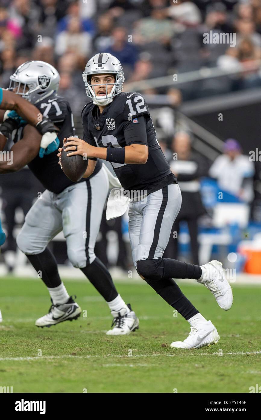Las Vegas Raiders quarterback Aidan O'Connell (10) rolls out against ...