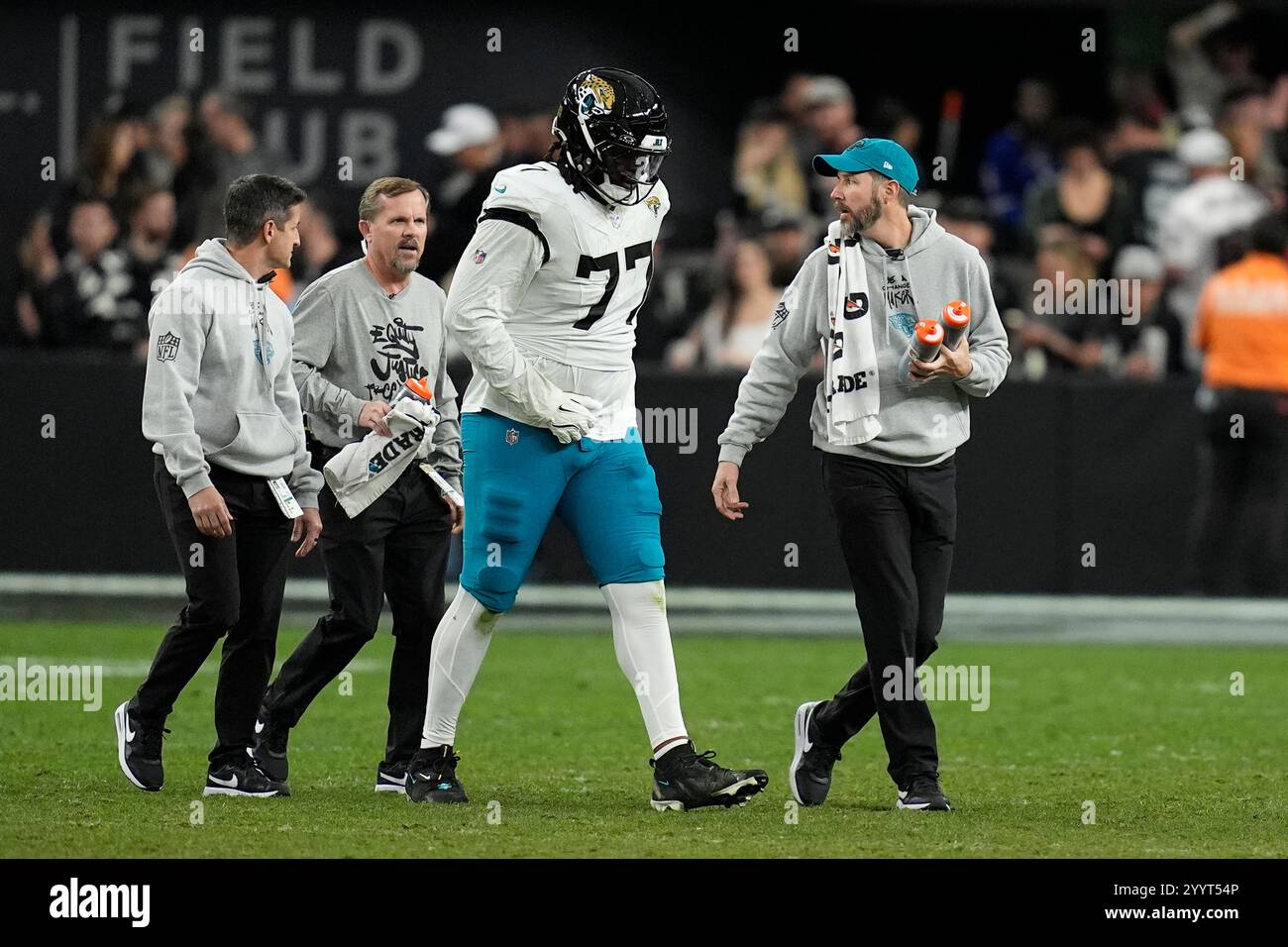An injured Jacksonville Jaguars offensive tackle Anton Harrison walks ...