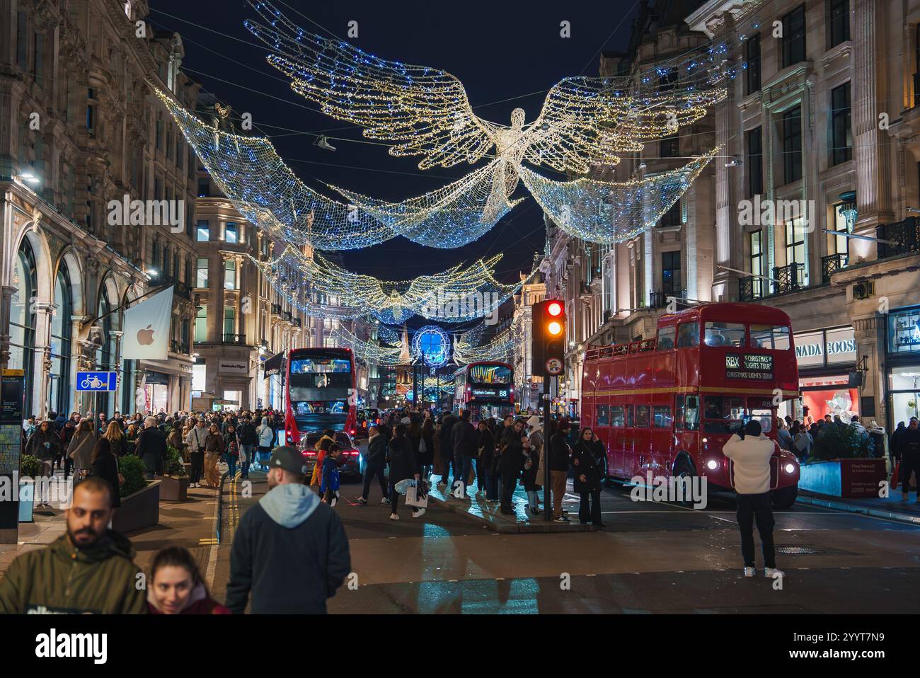 A bustling London street during Christmas, featuring red double decker ...