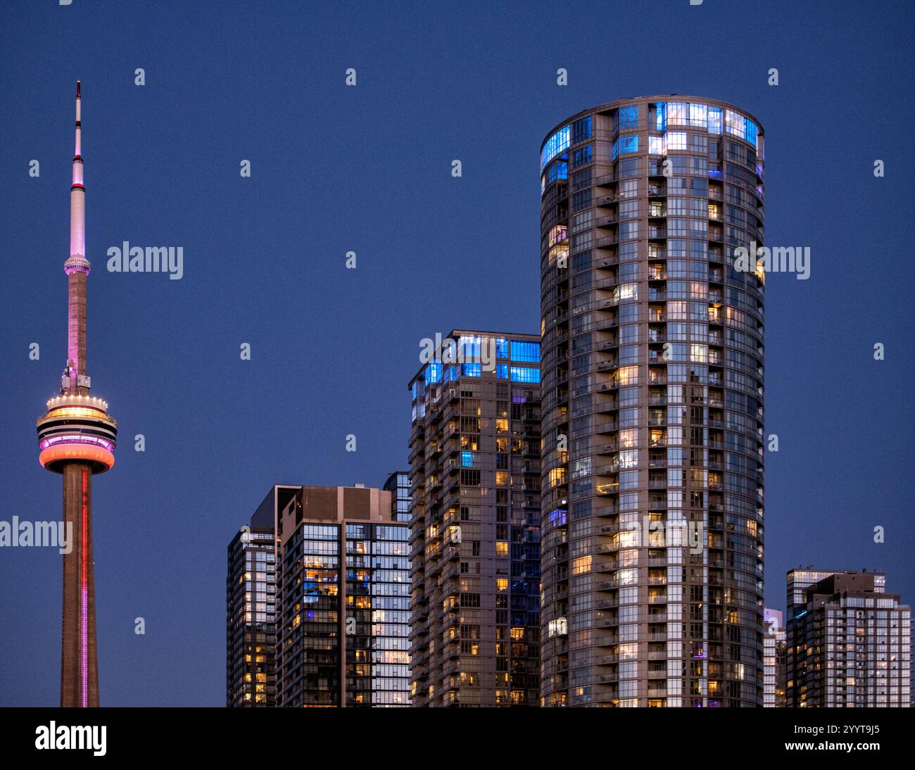 CN Tower illuminated against the twilight sky, a vibrant symbol of ...